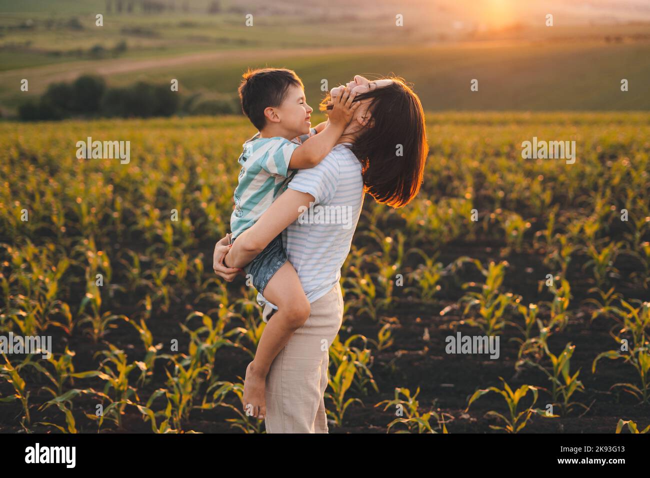 Happy young caucasian mother and her son having fun outdoor on a summer ...