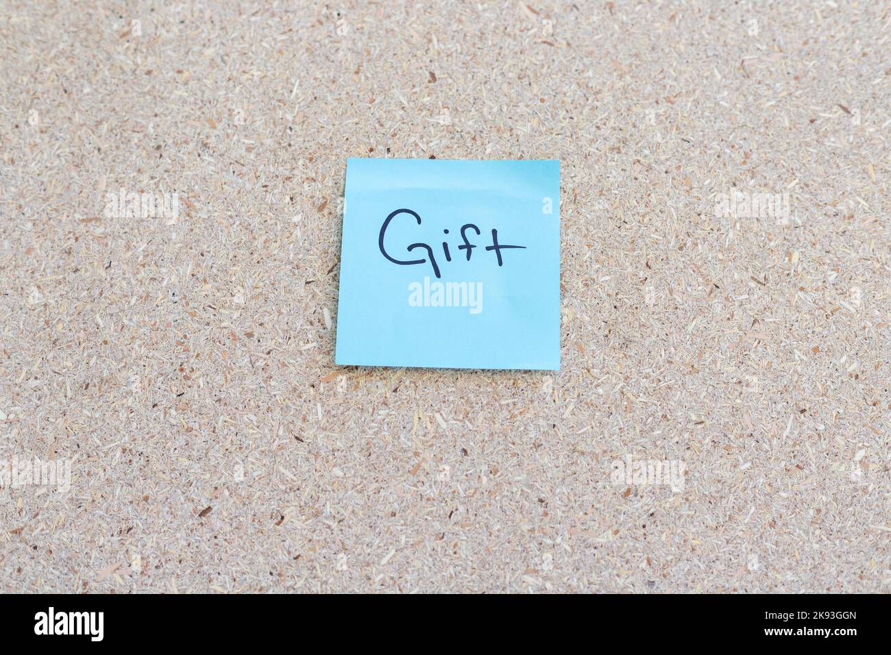 A memo note with a text GIFT on cork board background Stock Photo - Alamy