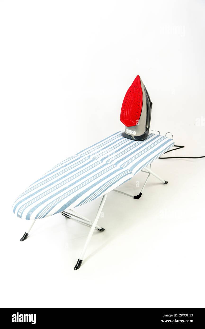 new clothes iron on white background, red ceramic iron, and blue fabric ...