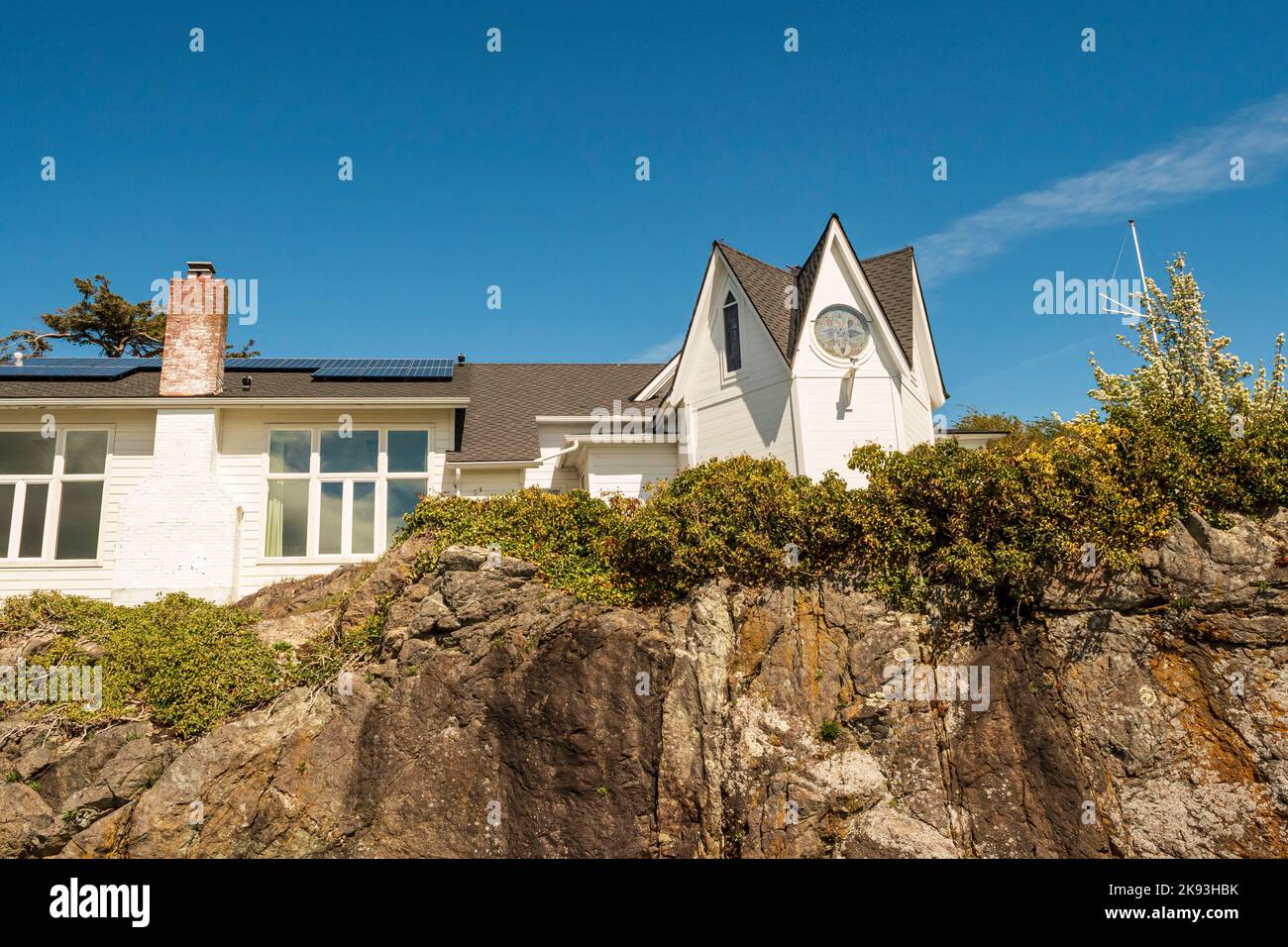 The white Emmanuel Episcopal church sits above a seaside cliff in ...