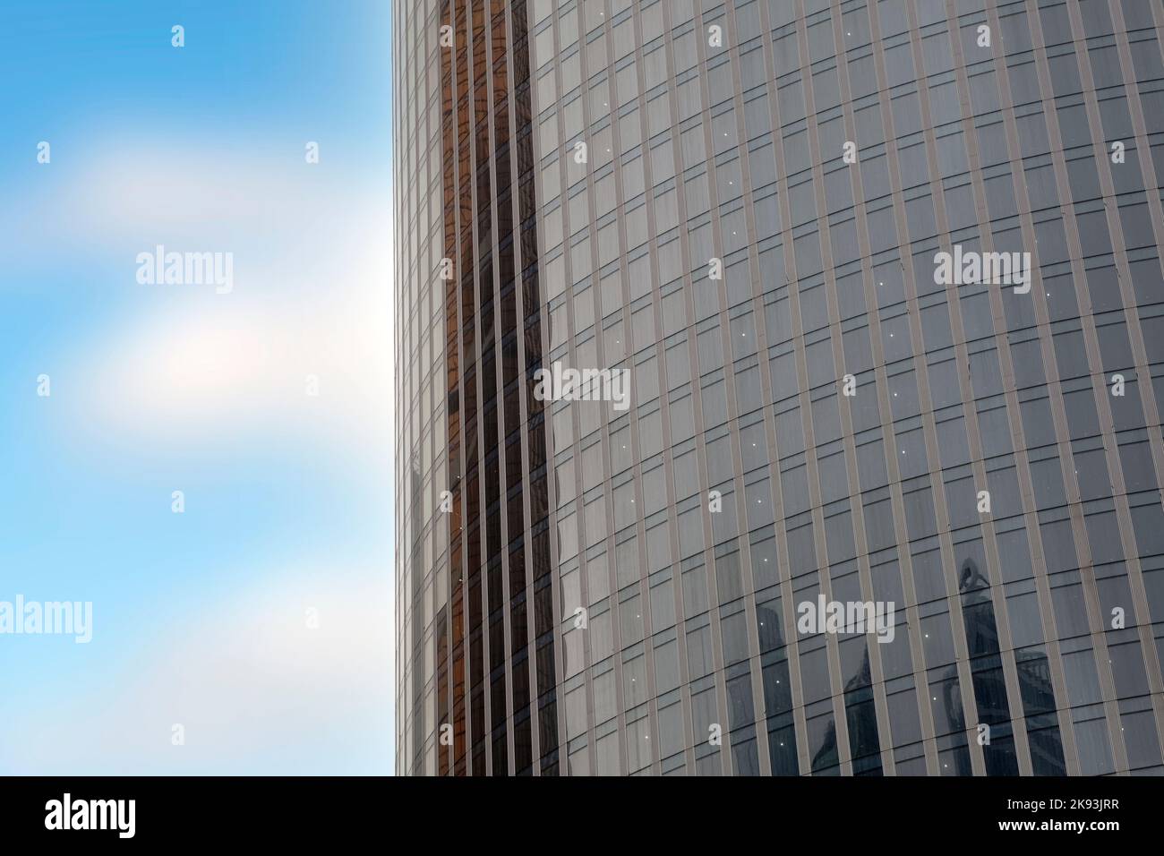 Facade of modern skyscraper with glass windows. From below of ...