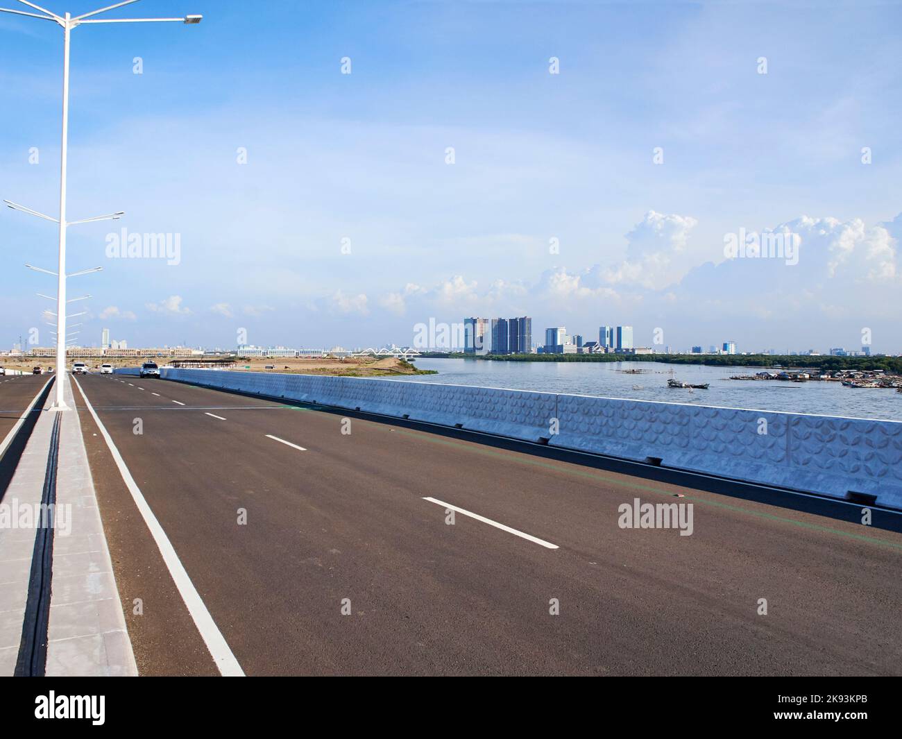 Road on a connecting bridge in the reclaimed beach area, Pantai Indah ...
