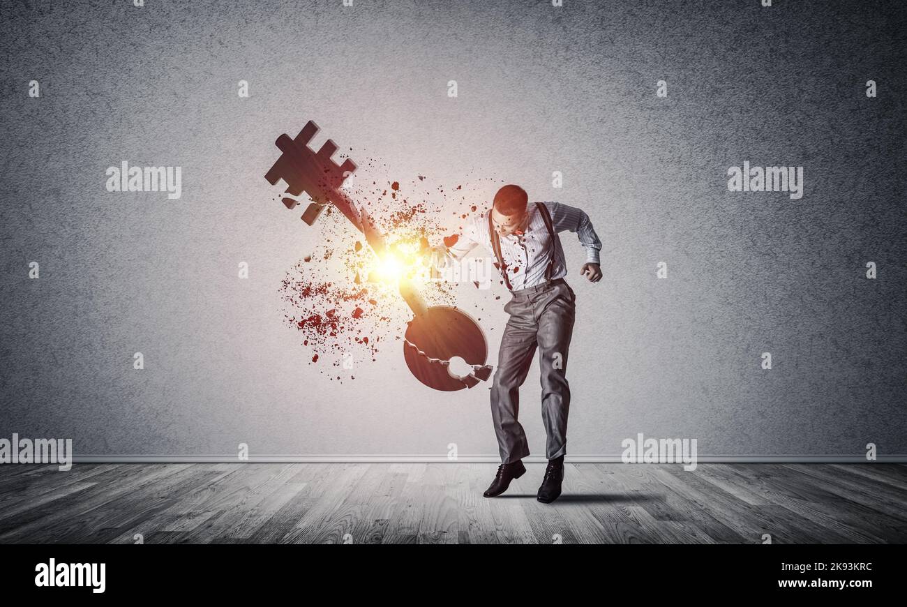 Breaking through access concept with man in room crashing concrete key ...