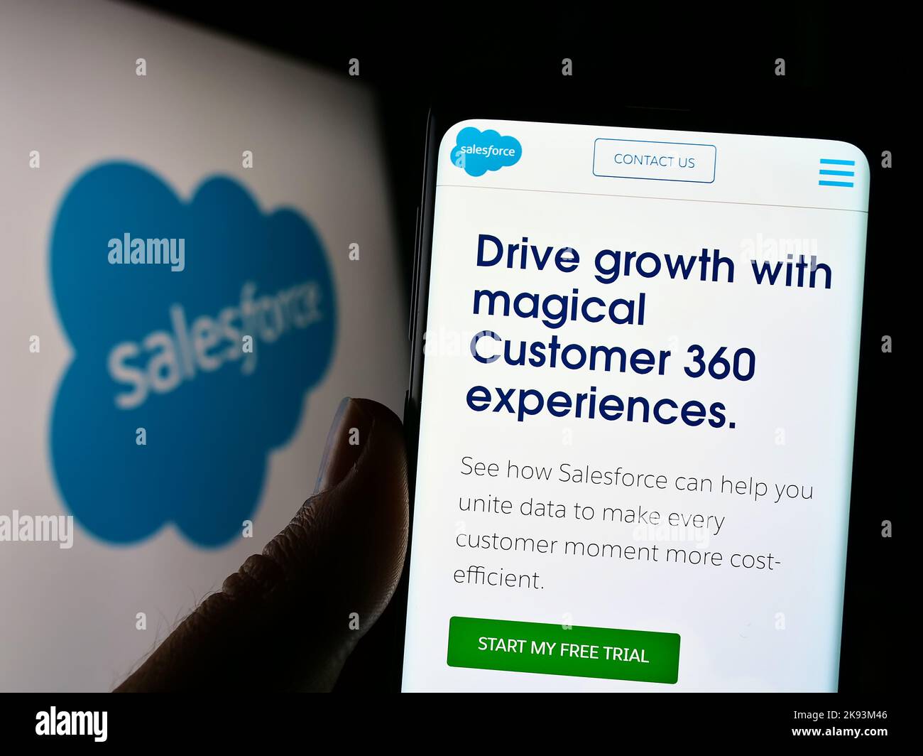 Person holding smartphone with website of US software company ...