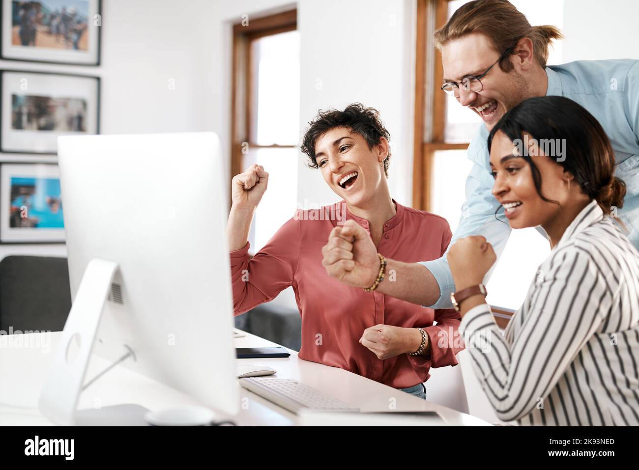 We did it. a diverse group of businesspeople celebrating while working ...