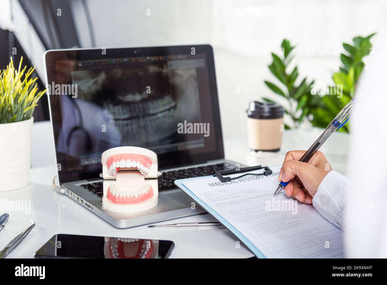 Oral dental. Dentist doctor in uniform writing information of patient ...