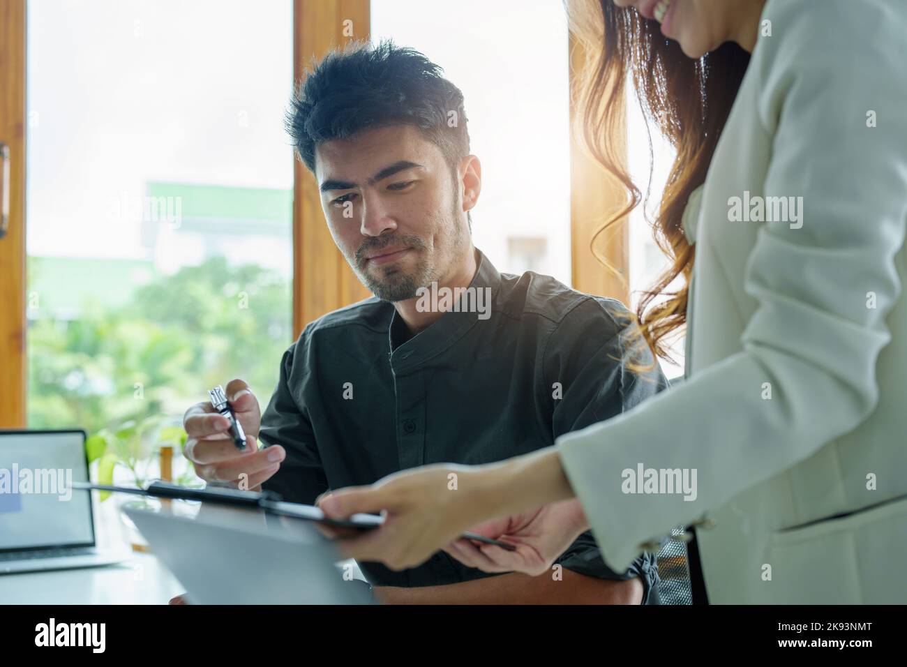 A portrait of a female marketer and a male salesperson discussing how ...