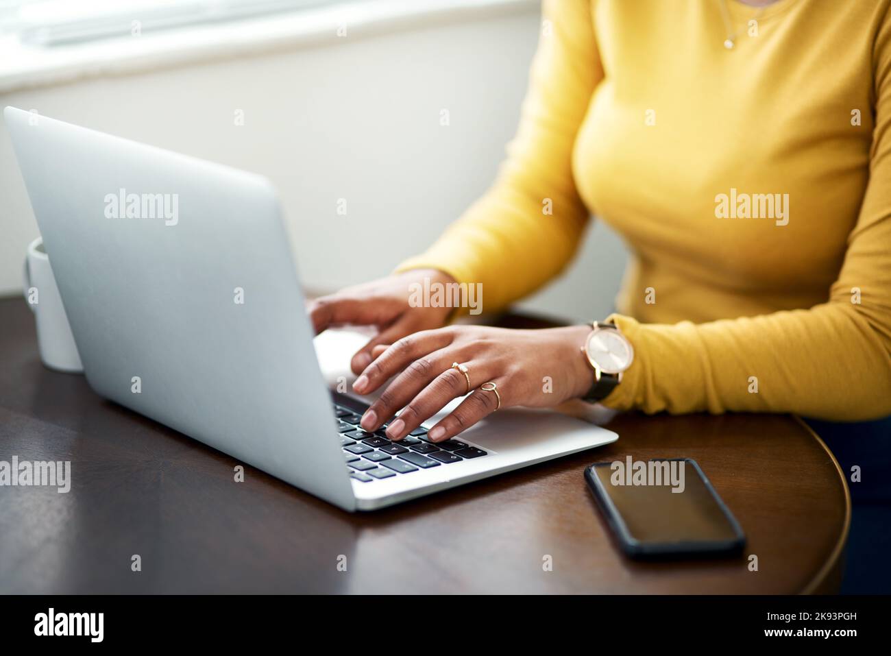 Technology keeps us connected. an unrecognizable woman sitting alone in ...