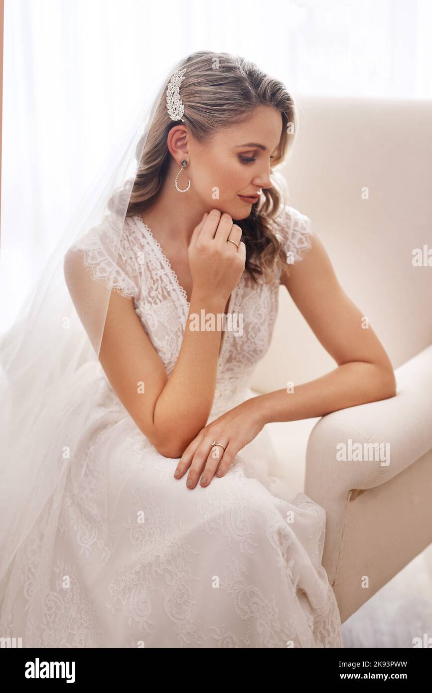 Thinking but not of second thoughts. an attractive young bride sitting ...