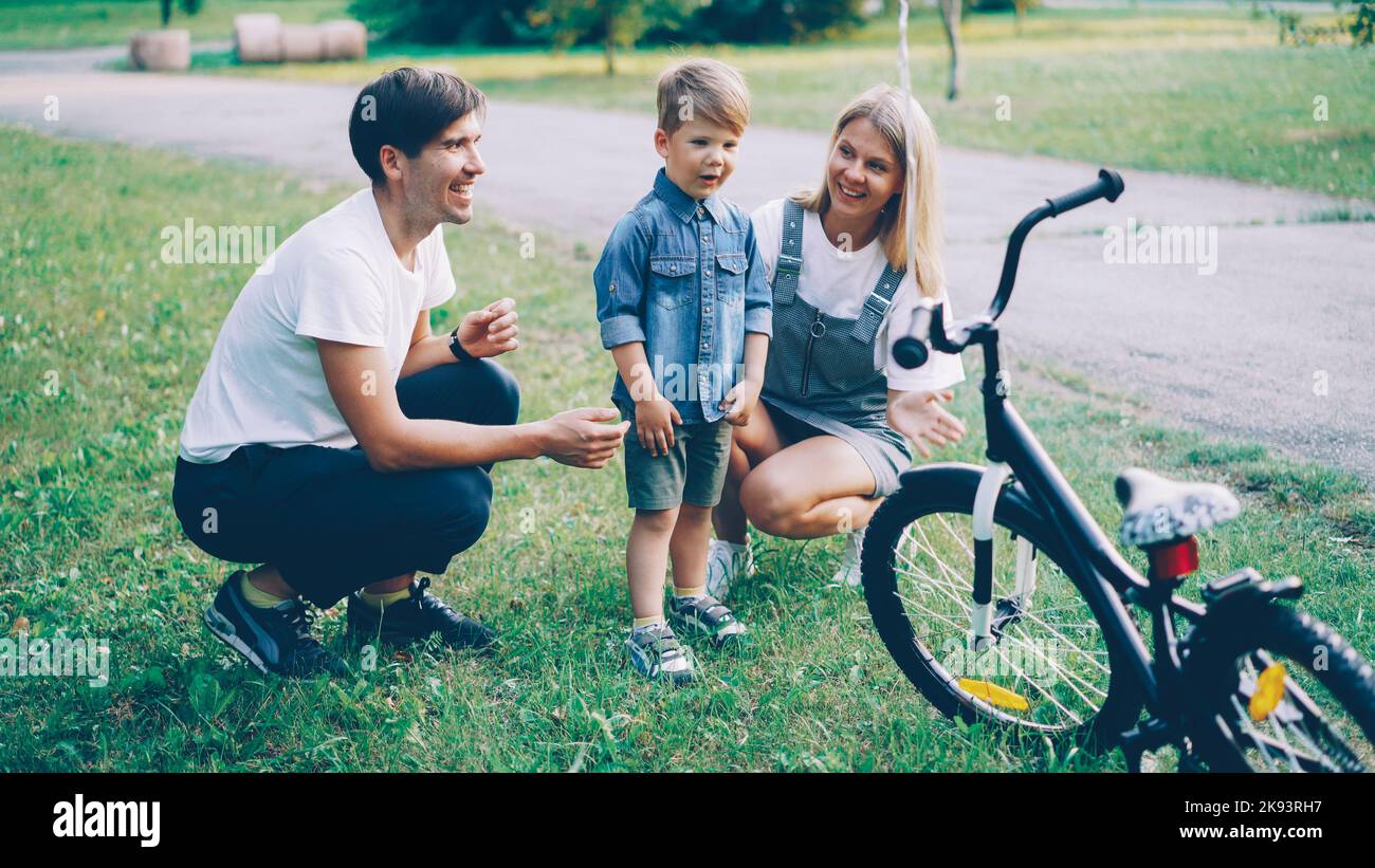 Loving parents are making surprise for little son closing his eyes and ...