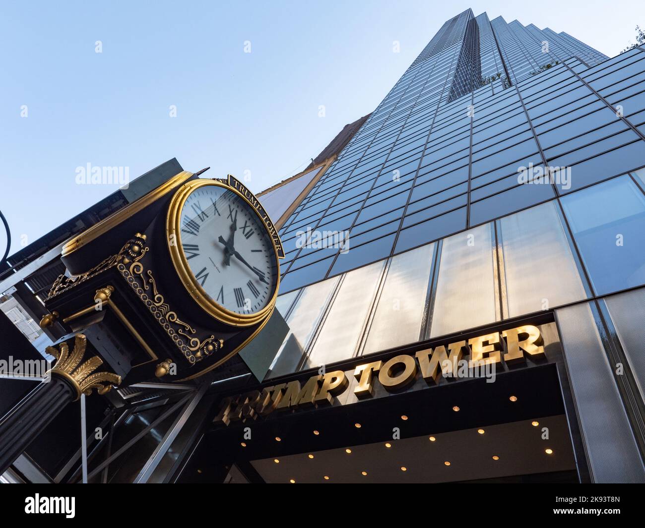 A clock in front of the entrance to Trump Tower in New York City. Photo ...