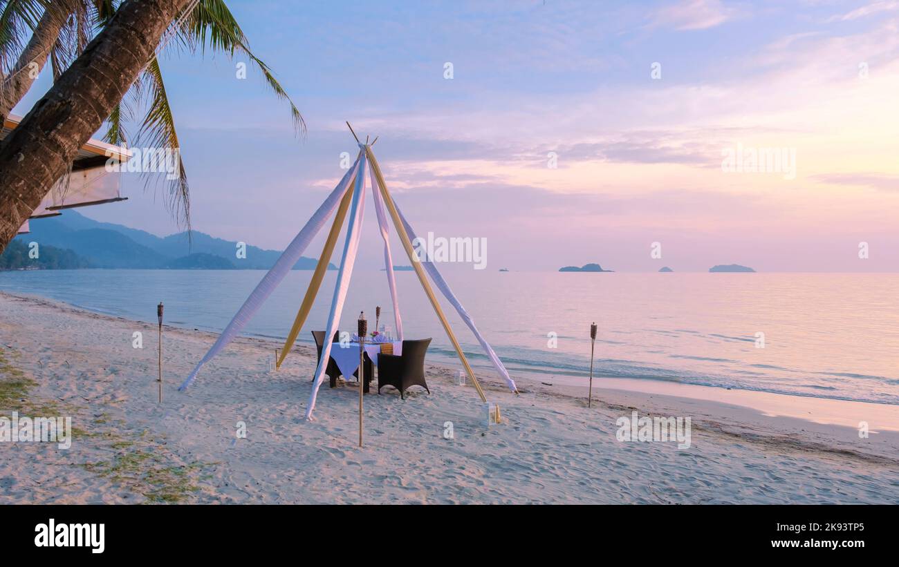 Romantic dinner on a beach in Koh Chang Thailand during sunset. Table ...
