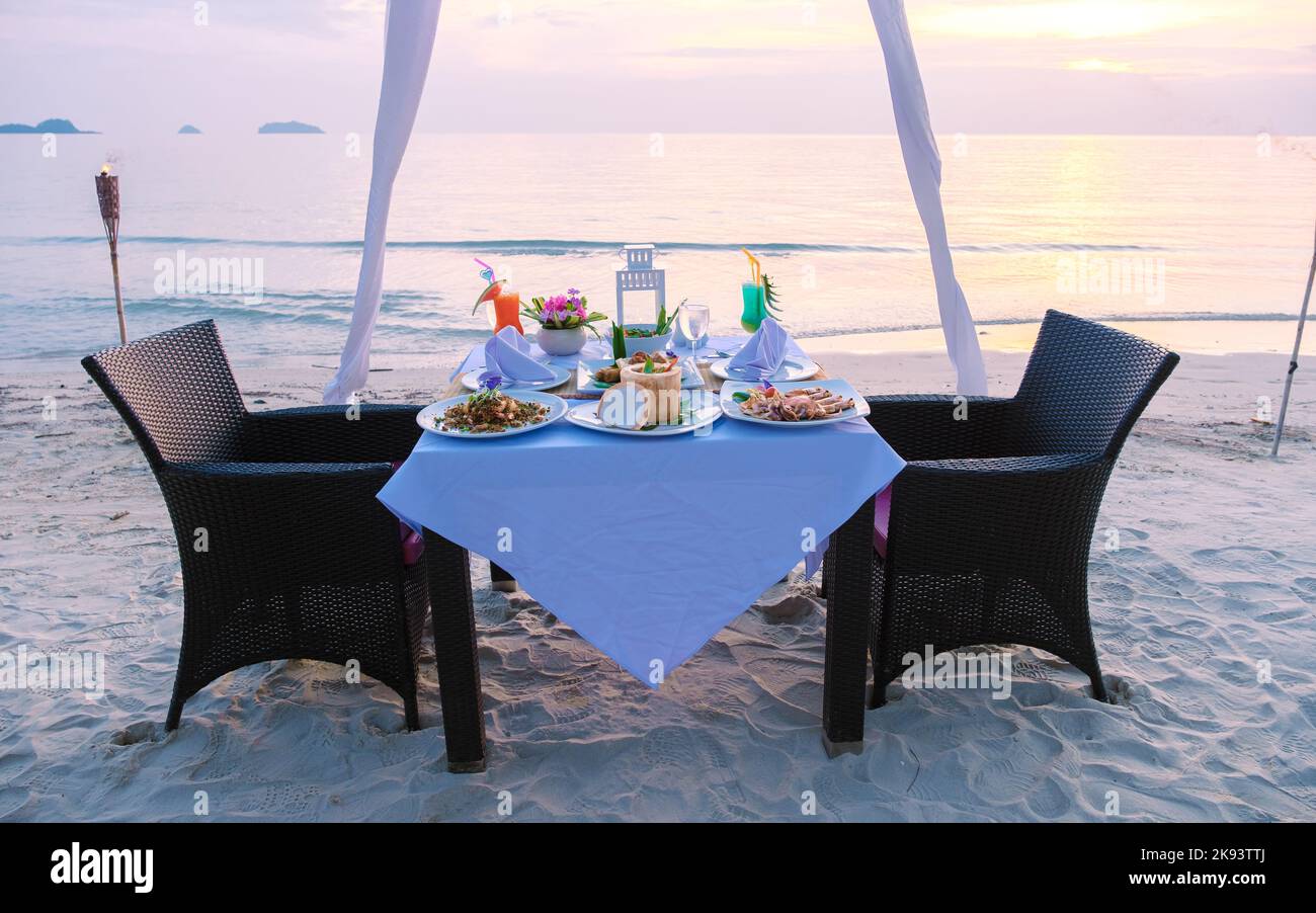 Close-up of the dinner table on the beach during sunset, Romantic ...