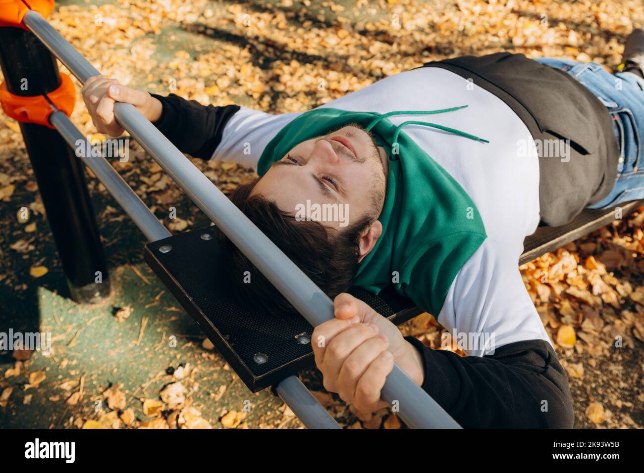 Young caucasian unshaven man 34 years old lies on inclined sloping ...