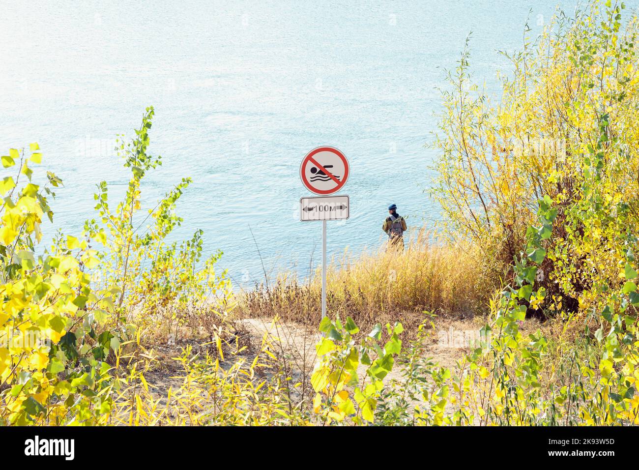 No Swimming red sign, 100 meter border. Yellow leaves of trees a lot ...