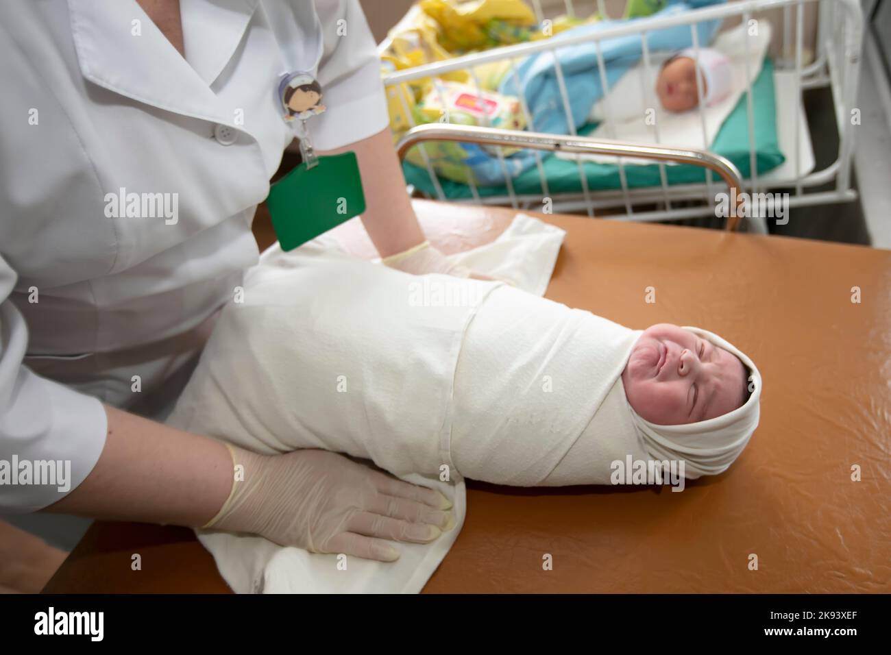 Neonatology. A newborn in a special incubator. medical staff caring for ...