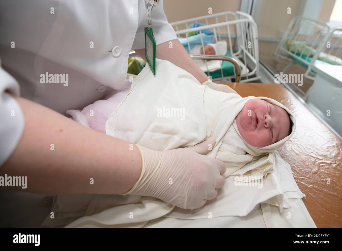 Neonatology. A newborn in a special incubator. medical staff caring for ...