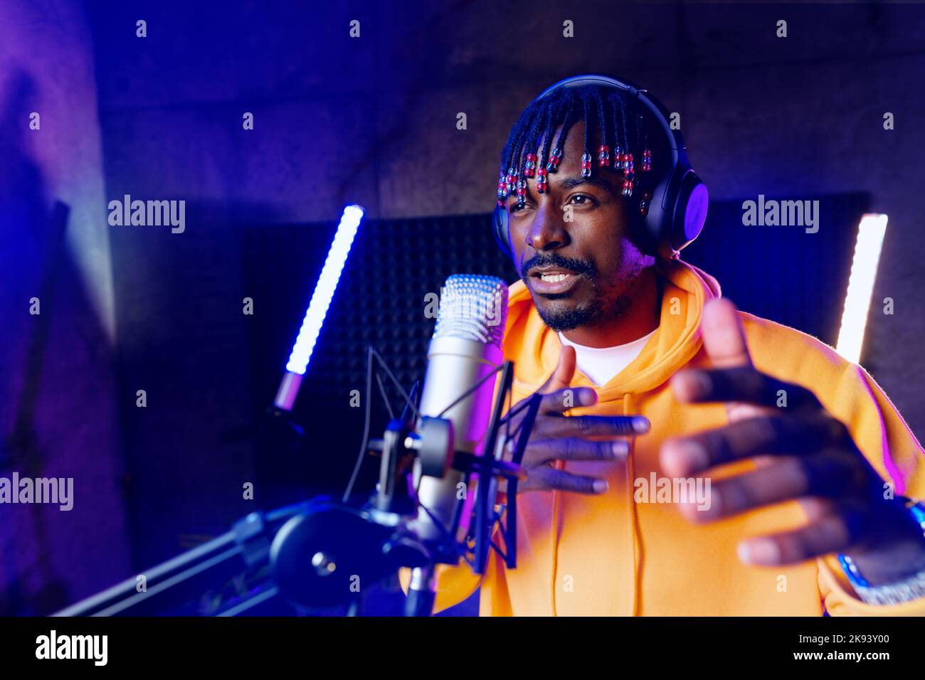 Young African performer recording his new track in recording studio ...