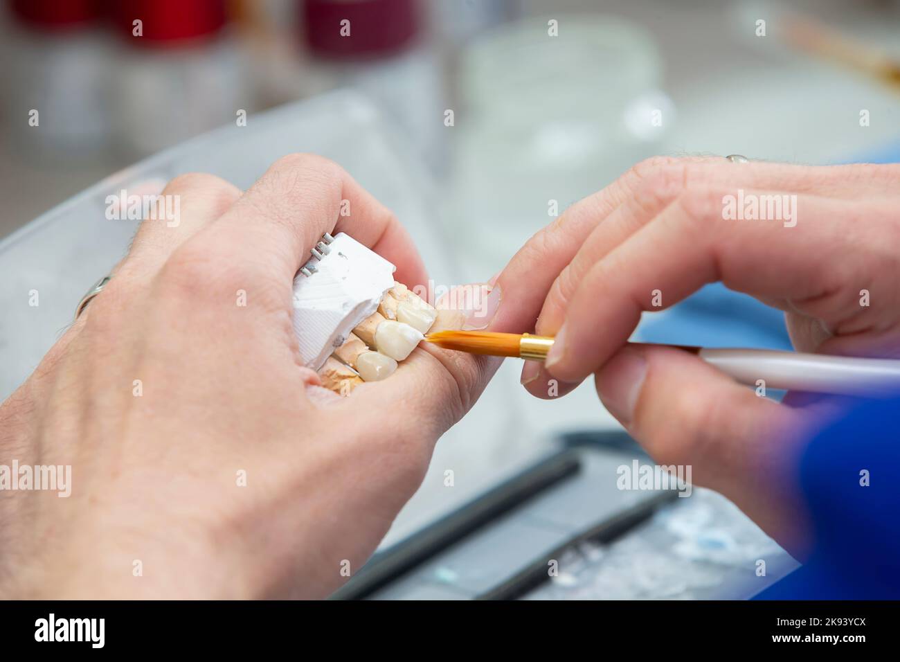 Manufacturing of dentures. Dental technician fixing a denture Stock ...