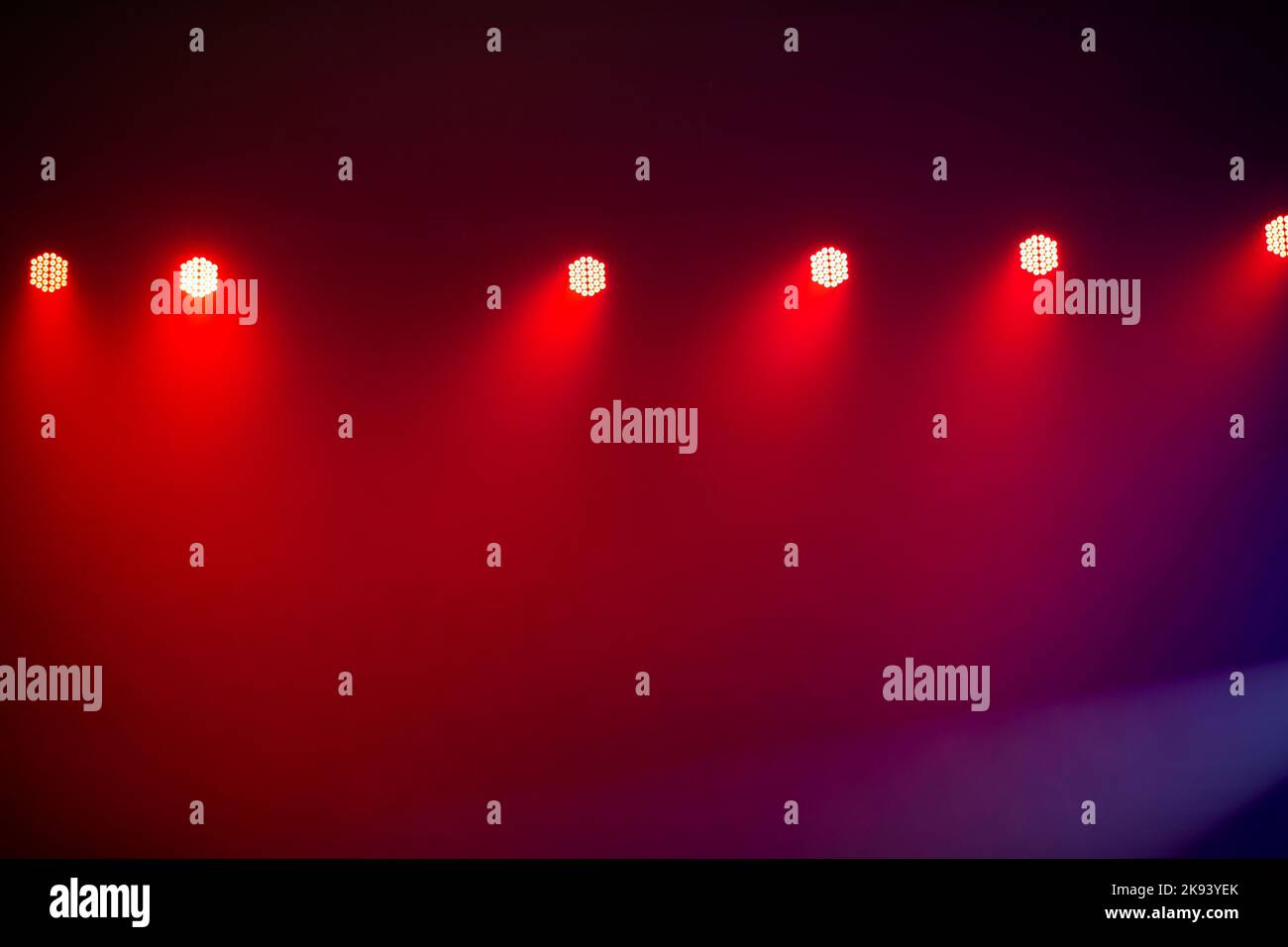 Red stage light from spotlights on a dark background Stock Photo - Alamy