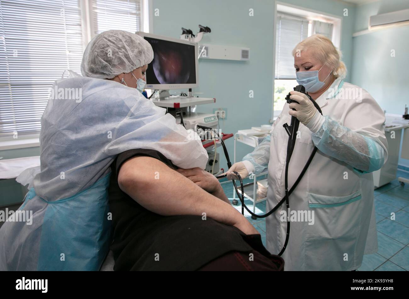A female doctor holds an endoscope during a gastroscopy for a hospital ...