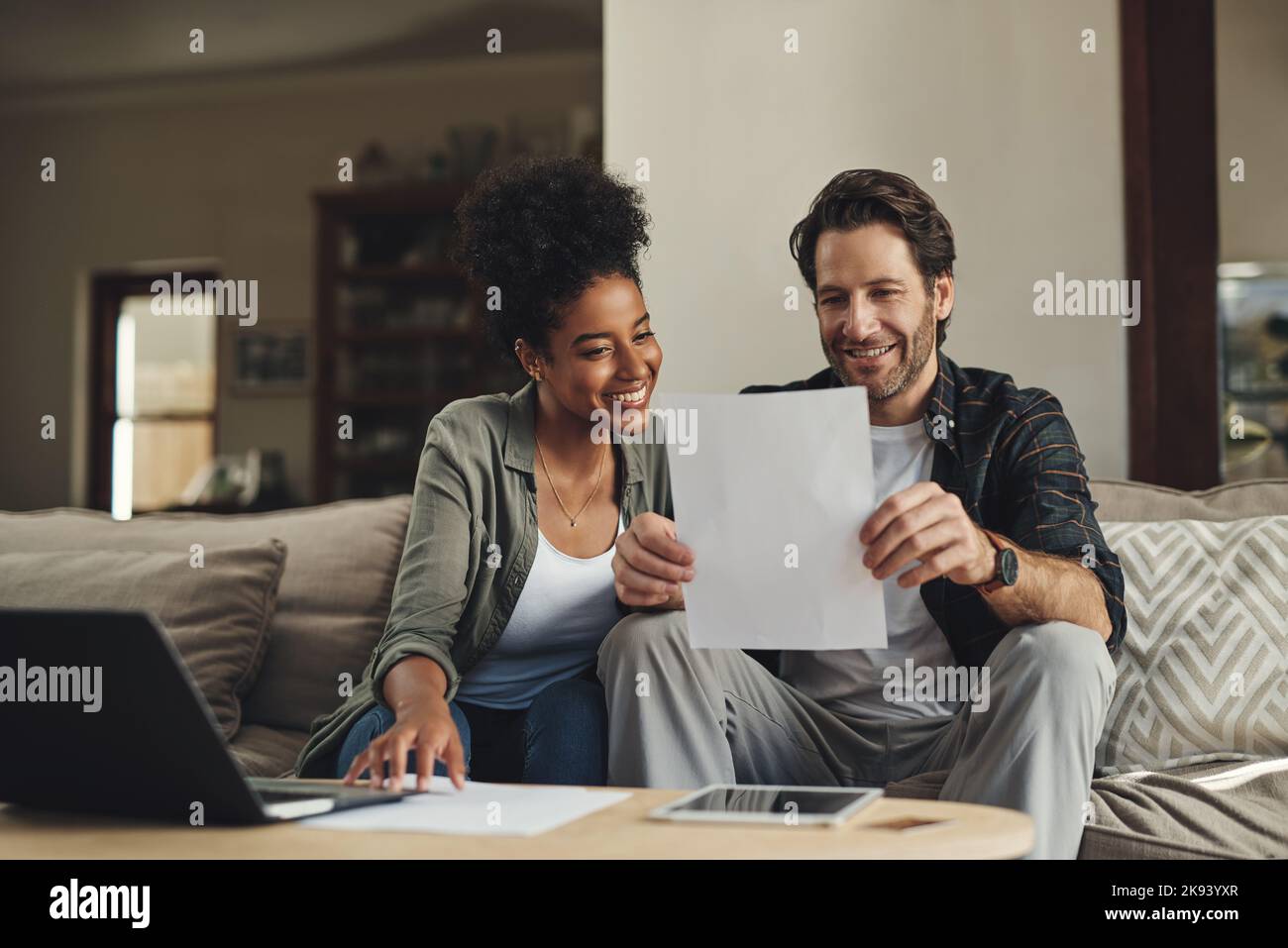 Planning on our future together. a happy young couple going over some ...
