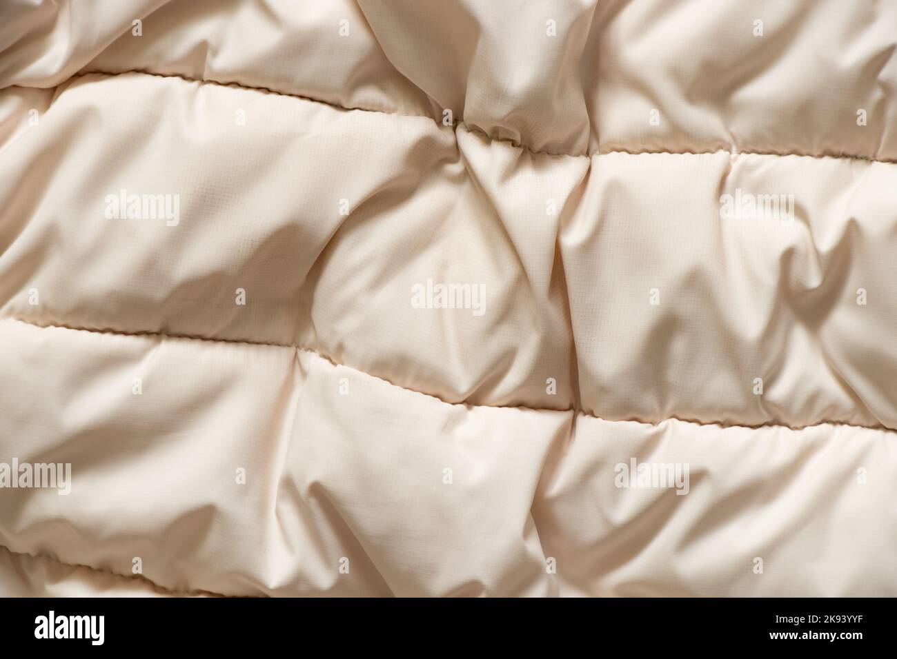 winter womens puffy white down jacket close up as background Stock ...