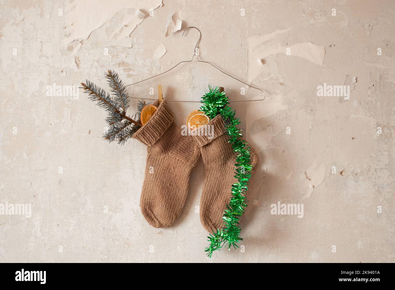 knitted socks with a New Year's tree branch and a dried orange and a ...