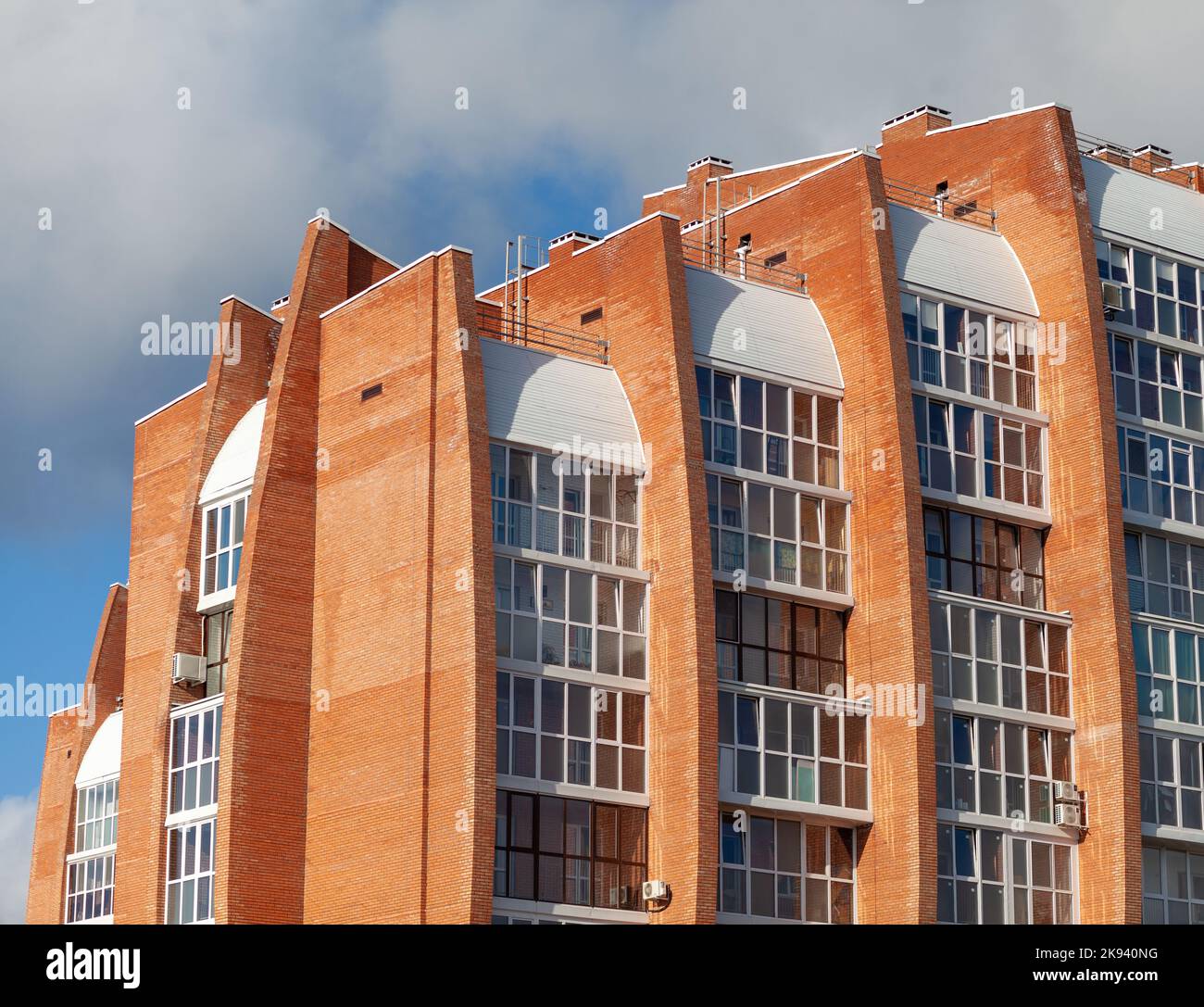 Windows of a residential multi-storey brick house. Modern buildings ...