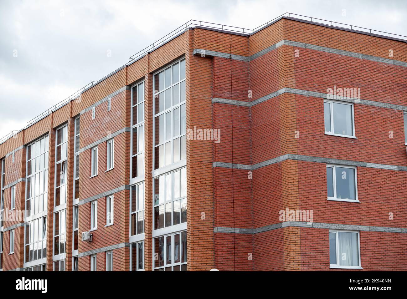 Windows of a residential multi-storey brick house. Modern buildings ...