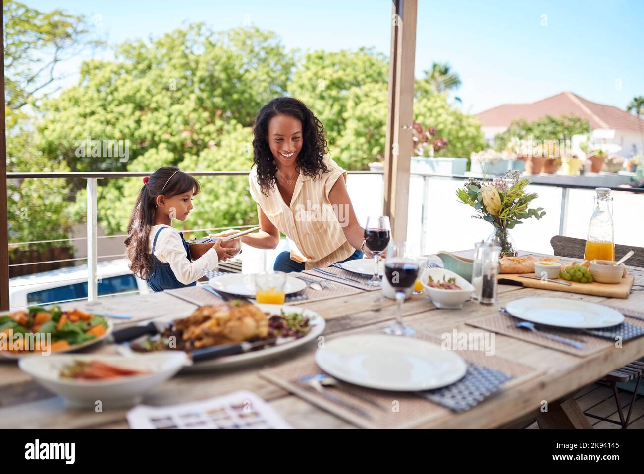 Were getting the dinner table ready together. a beautiful young mother ... Were getting the dinner table ready together. a beautiful young mother ...