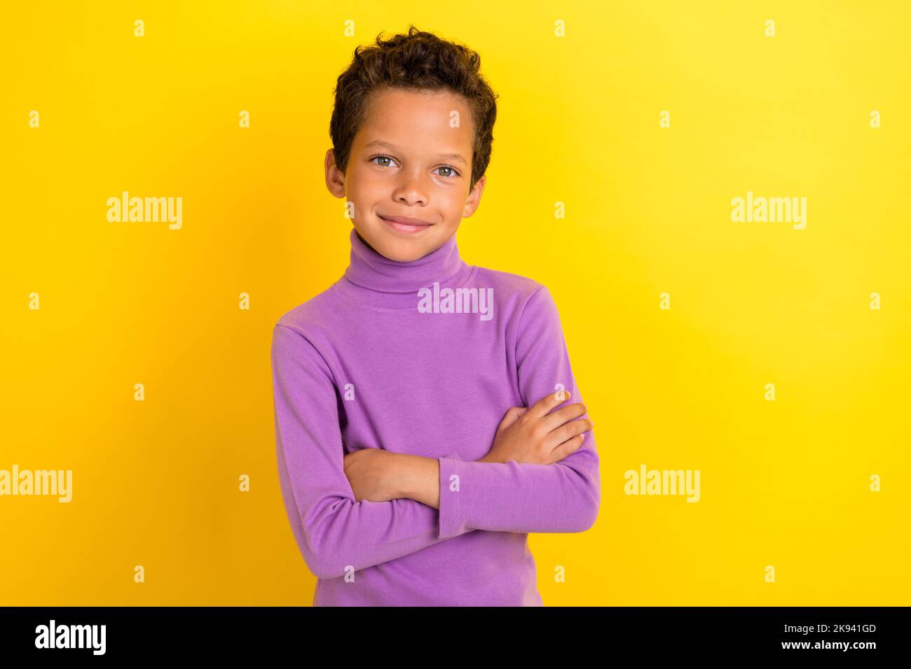Photo portrait of charming little boy folded hands smiling confident ...