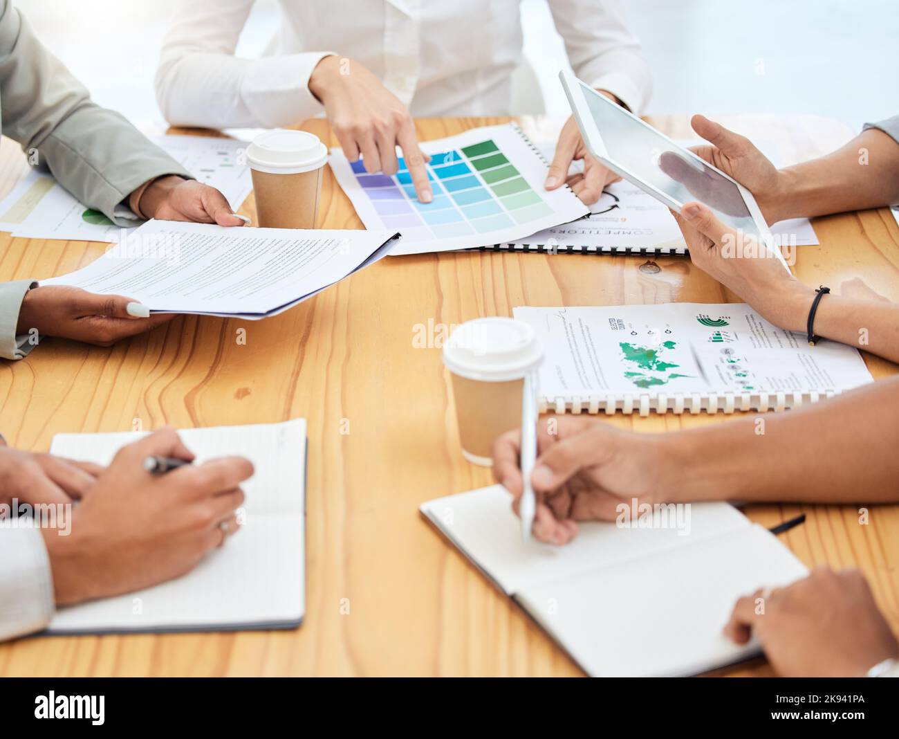Hands, finance and meeting with a team around a table in the boardroom ...