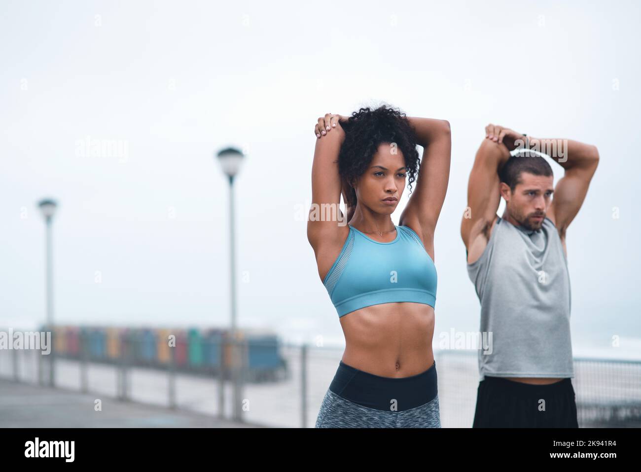Focused on getting their bodies loose and limber. two sporty young ...