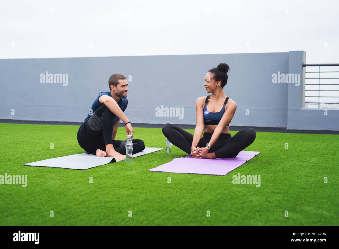 Yoga is their favourite peaceful hobby. a young man and woman taking a ...