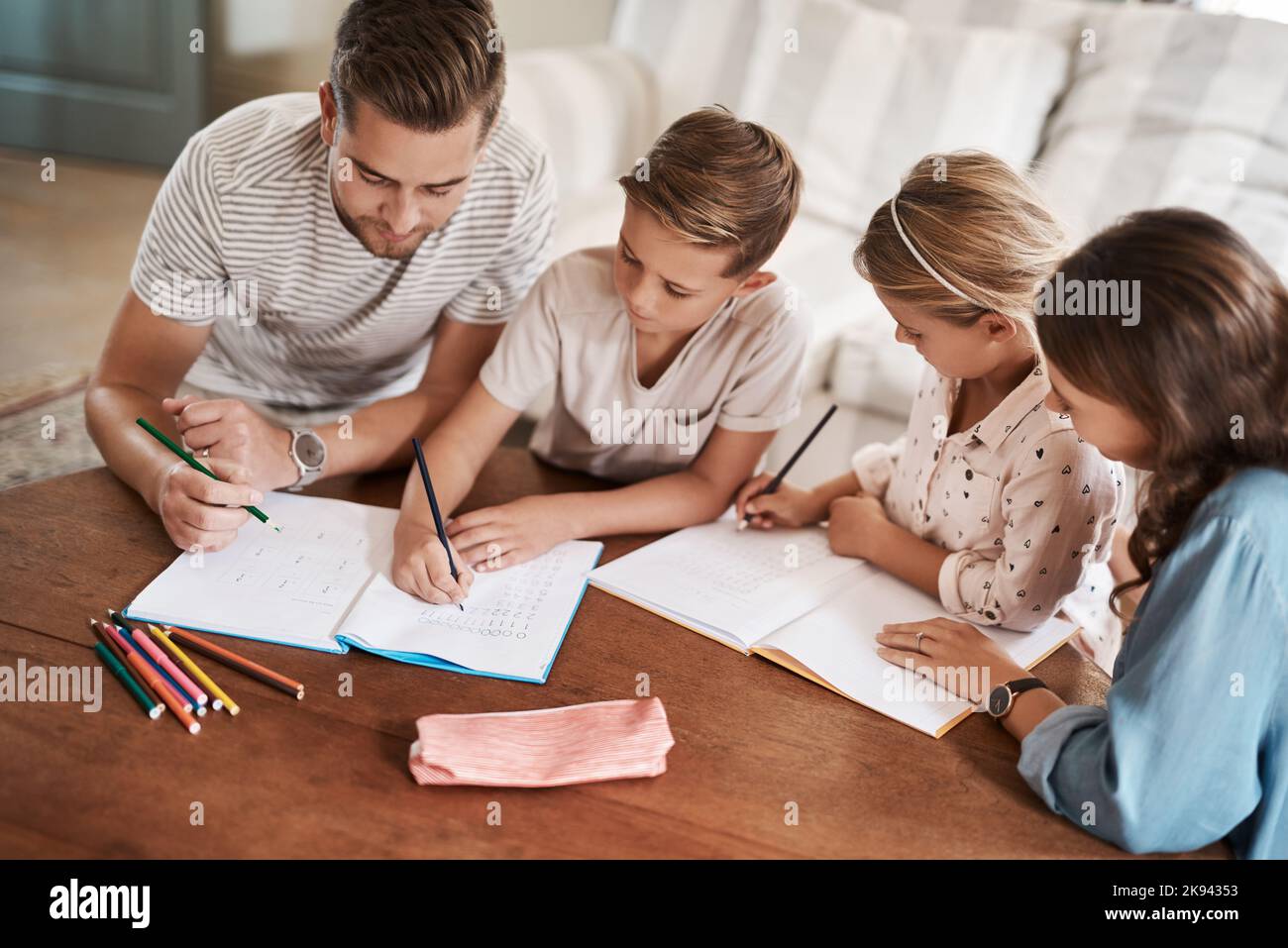 Theres a lot to learn from family. a happy young family of four doing ...