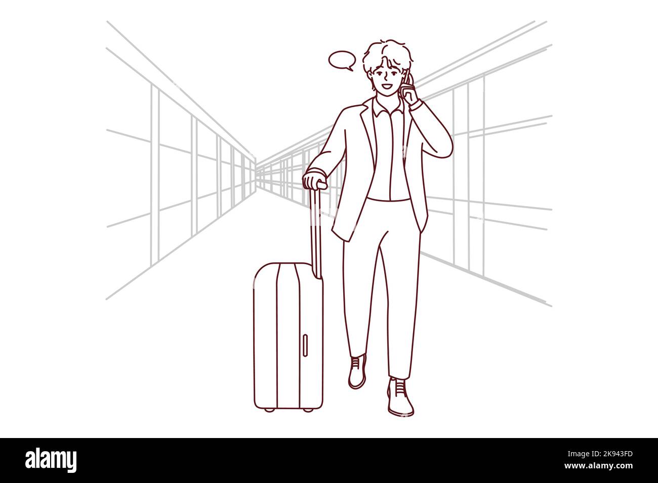 Young businessman with suitcase walking in airport talking on cellphone ...