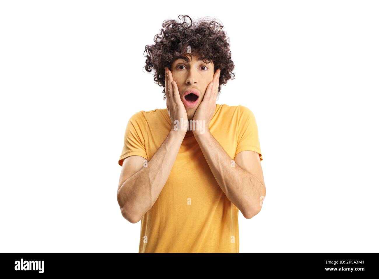 Shocked young man holding his face isolated on white background Stock ...