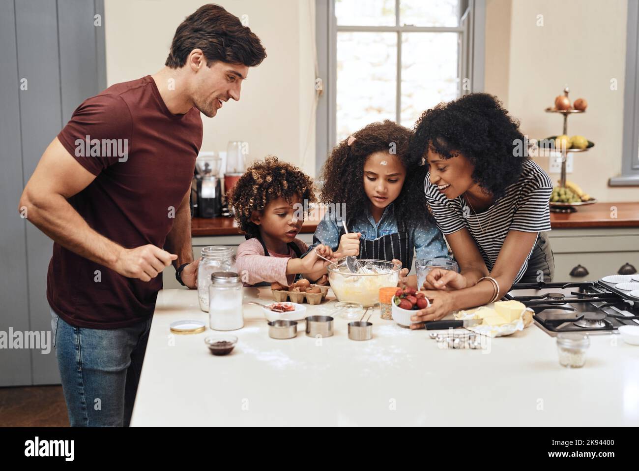 We cant wait to see the end result. a young couple baking at home with ...