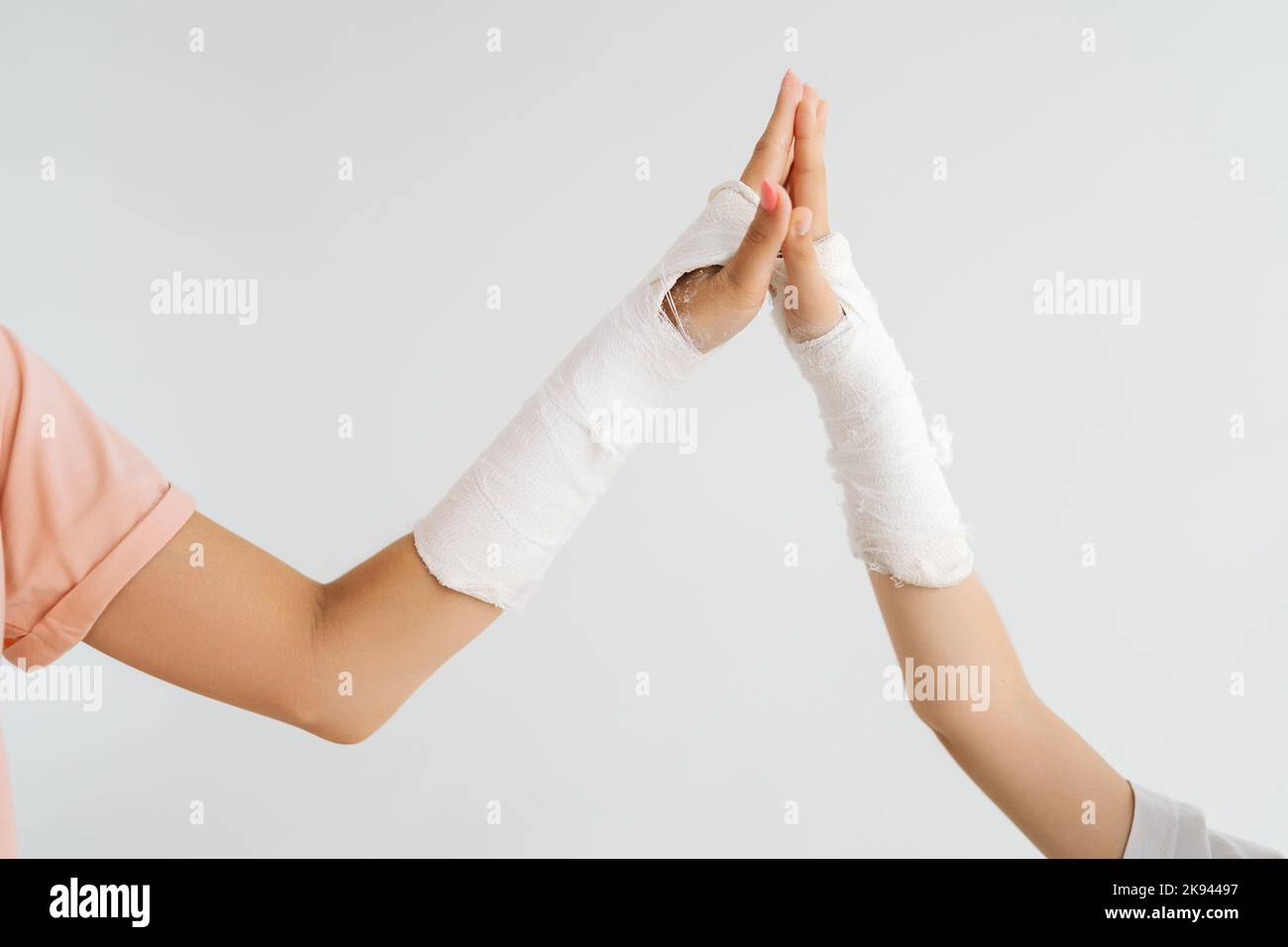Close-up cropped studio shot of unrecognizable injured woman and little ...