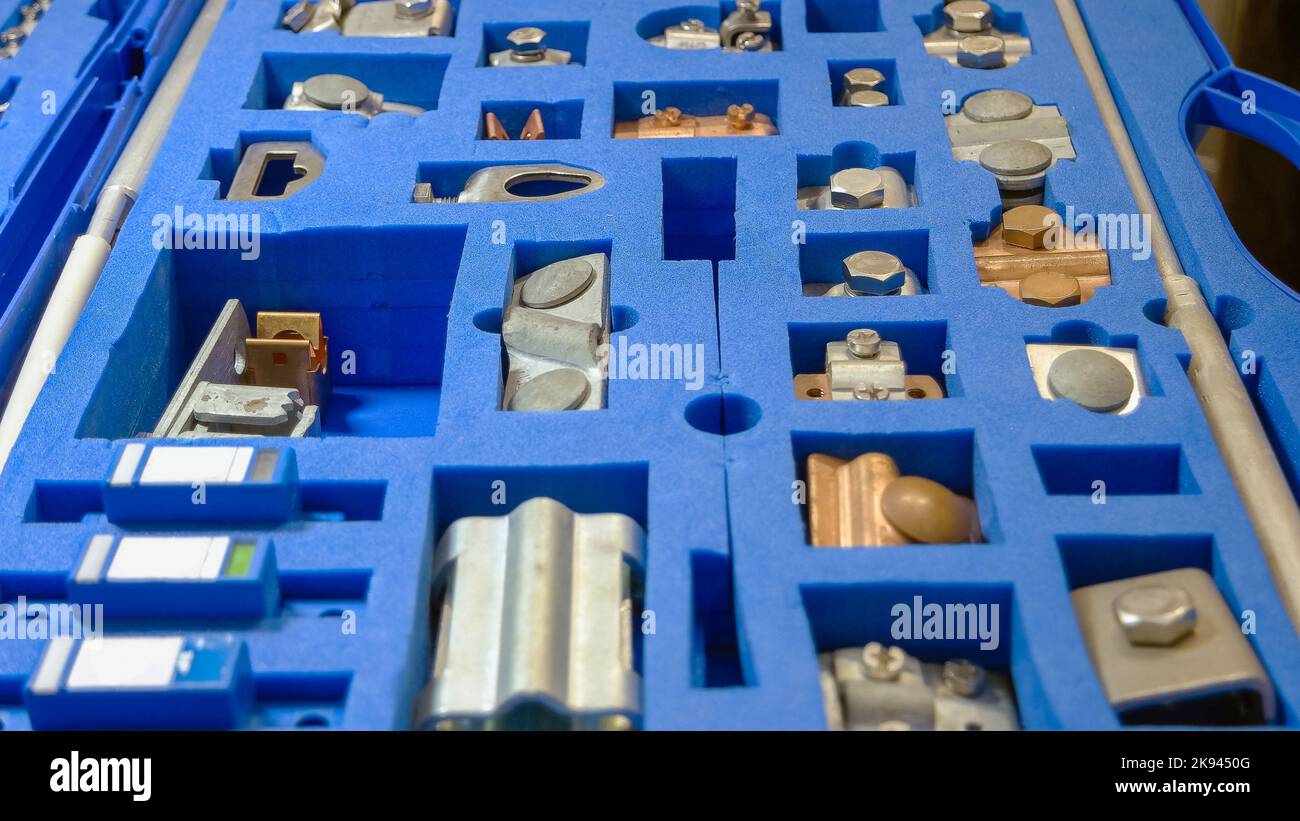 Set of metallic machine details in the blue foam rubber. Many various ...