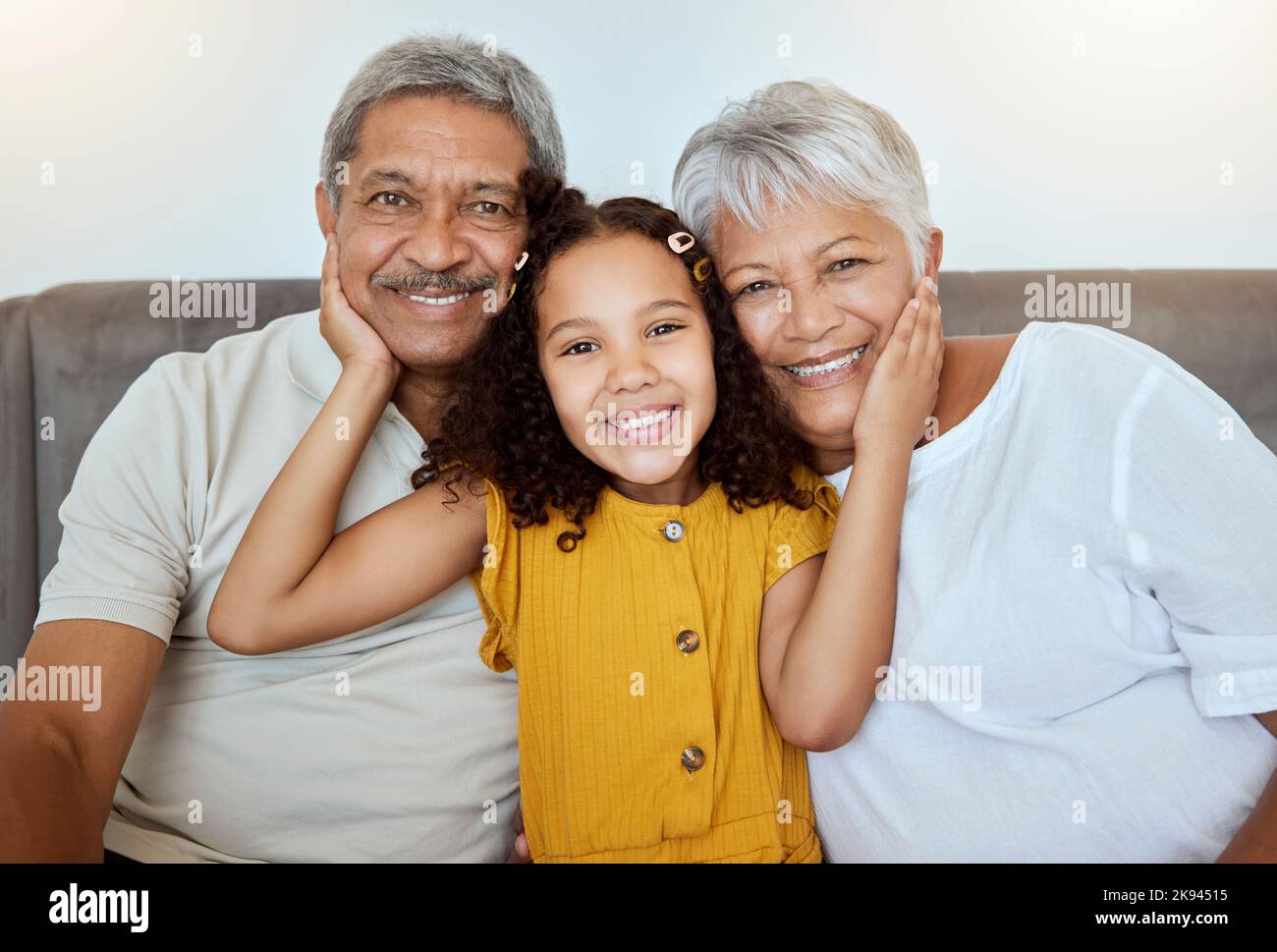 Family, happy and girl on a home living room sofa with grandparents ...