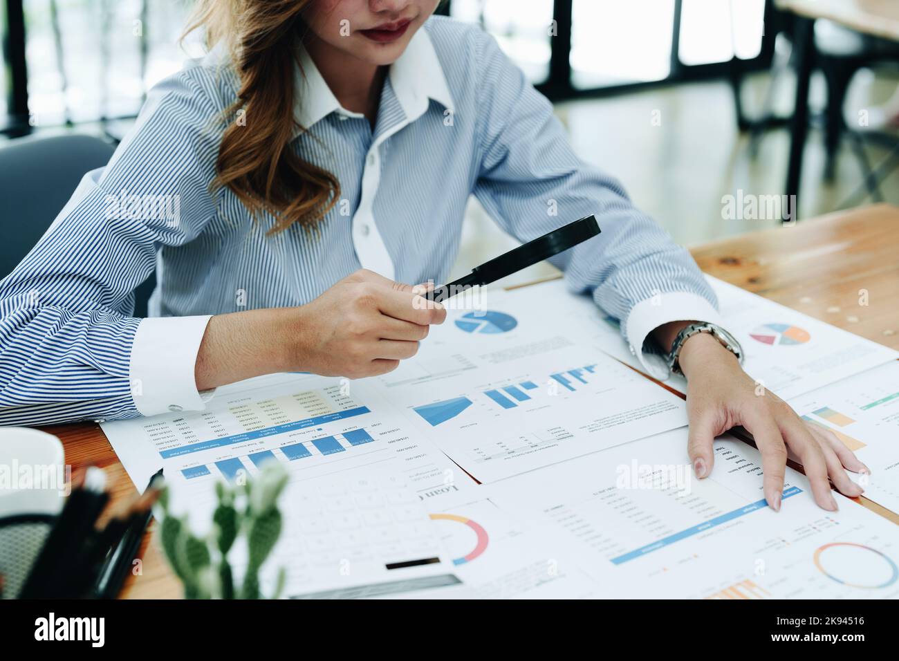 Financial analysts analyzing business financial reports are examining ...