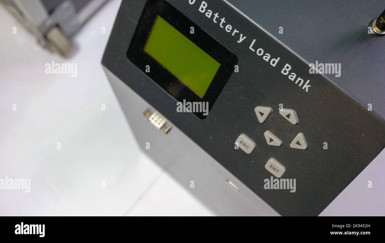 Turned off capacity battery load bank on white surface. Control panel ...