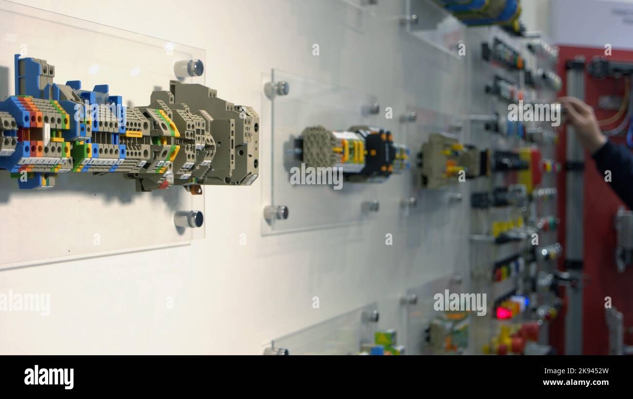 Electrical control panels on the white wall in the shop. Electrical ...