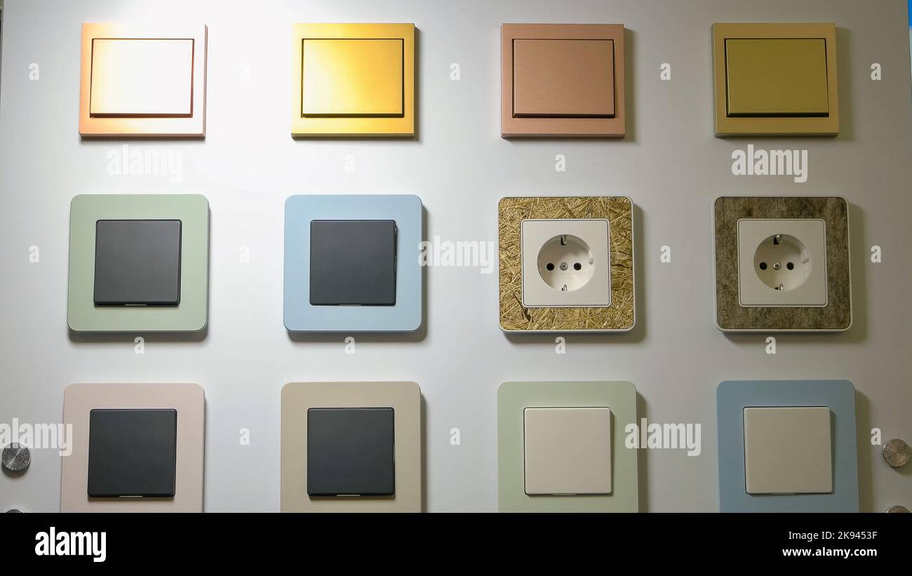 Various colored swithches and sockets on the wall. Electricity power ...