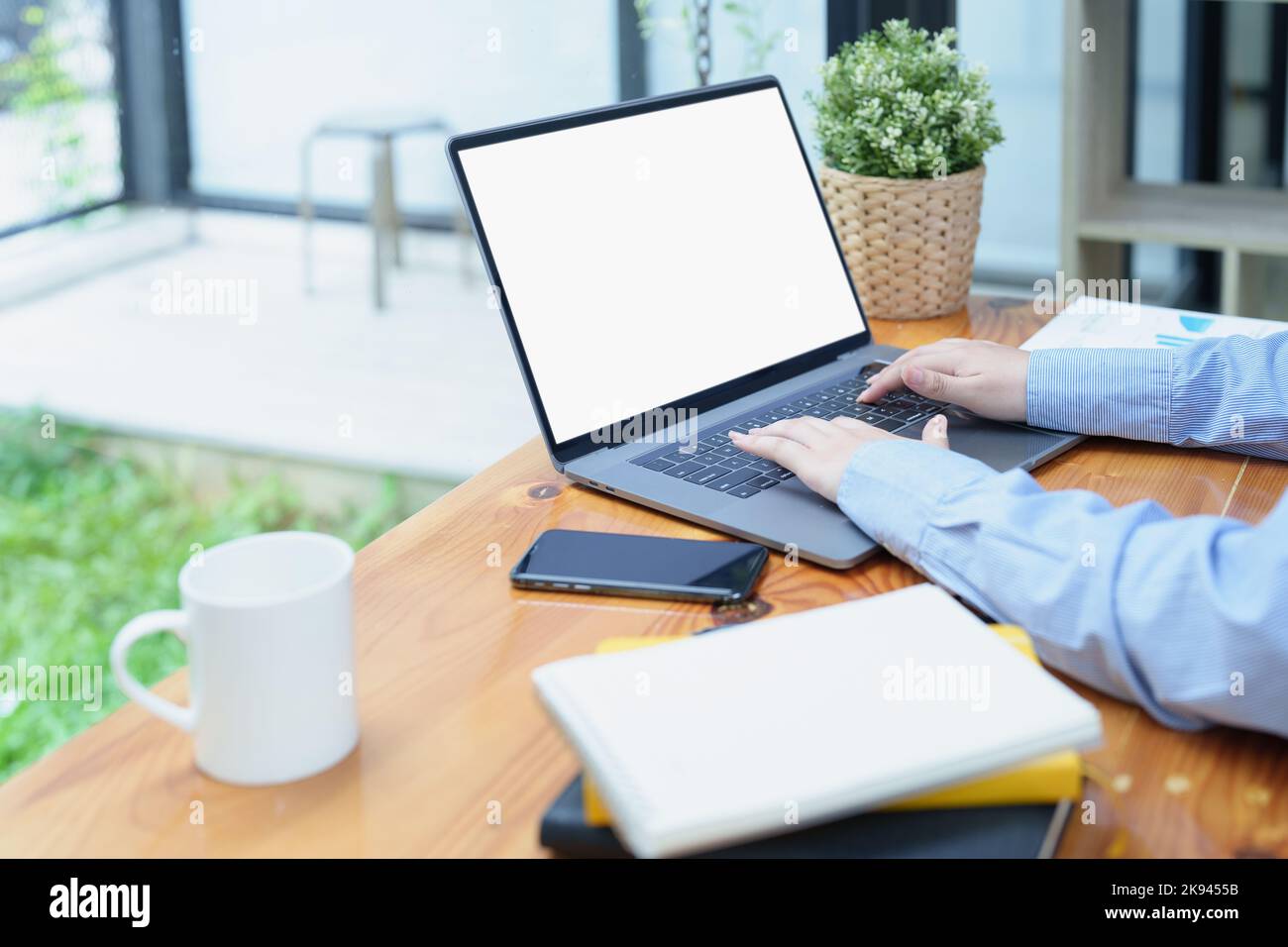 A white screen laptop computer placed on the desk at work. Can put text ...