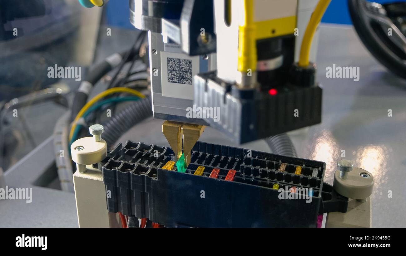 Close-up automatic manufacture robot pulling out a chip. Industrial ...