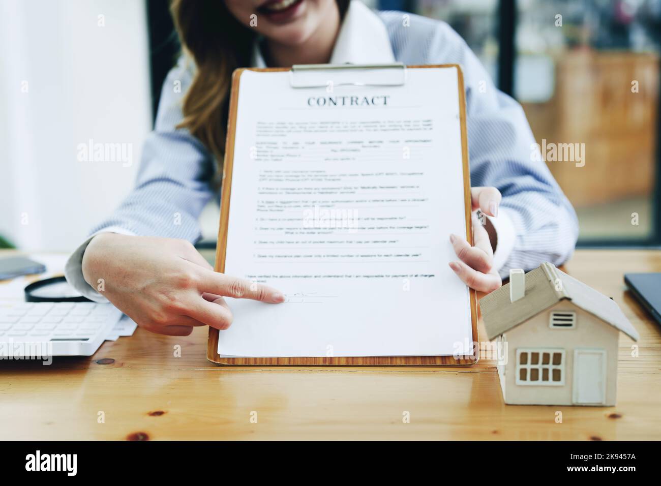 Portrait of a beautiful bank young woman sign credit department of ...