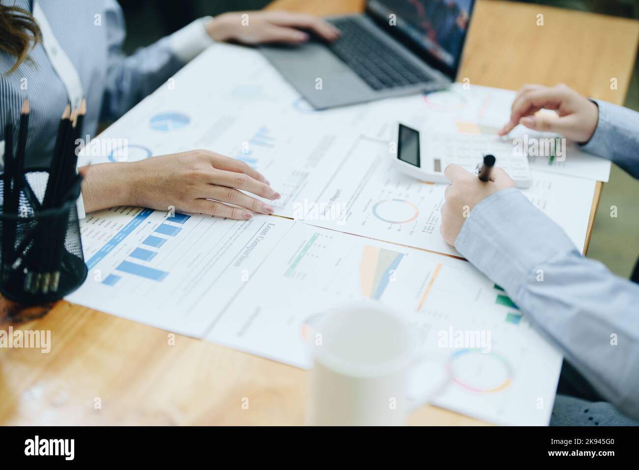 Financial analysts analyzing business reports on planned investment ...